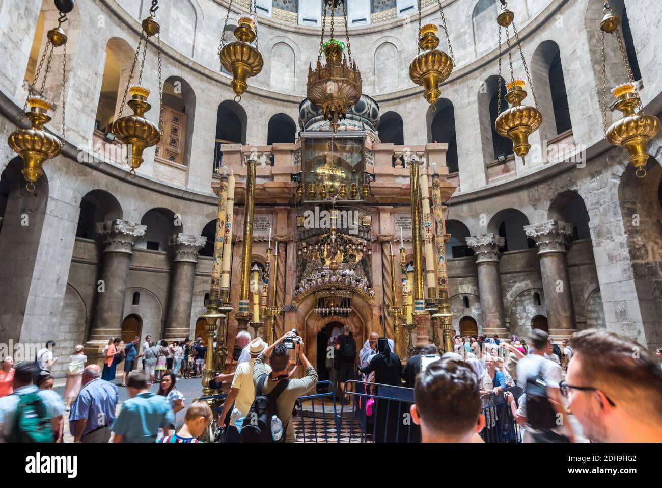 Tourists and pilgrims taking pictures of Jesus's empty tomb, where he ...
