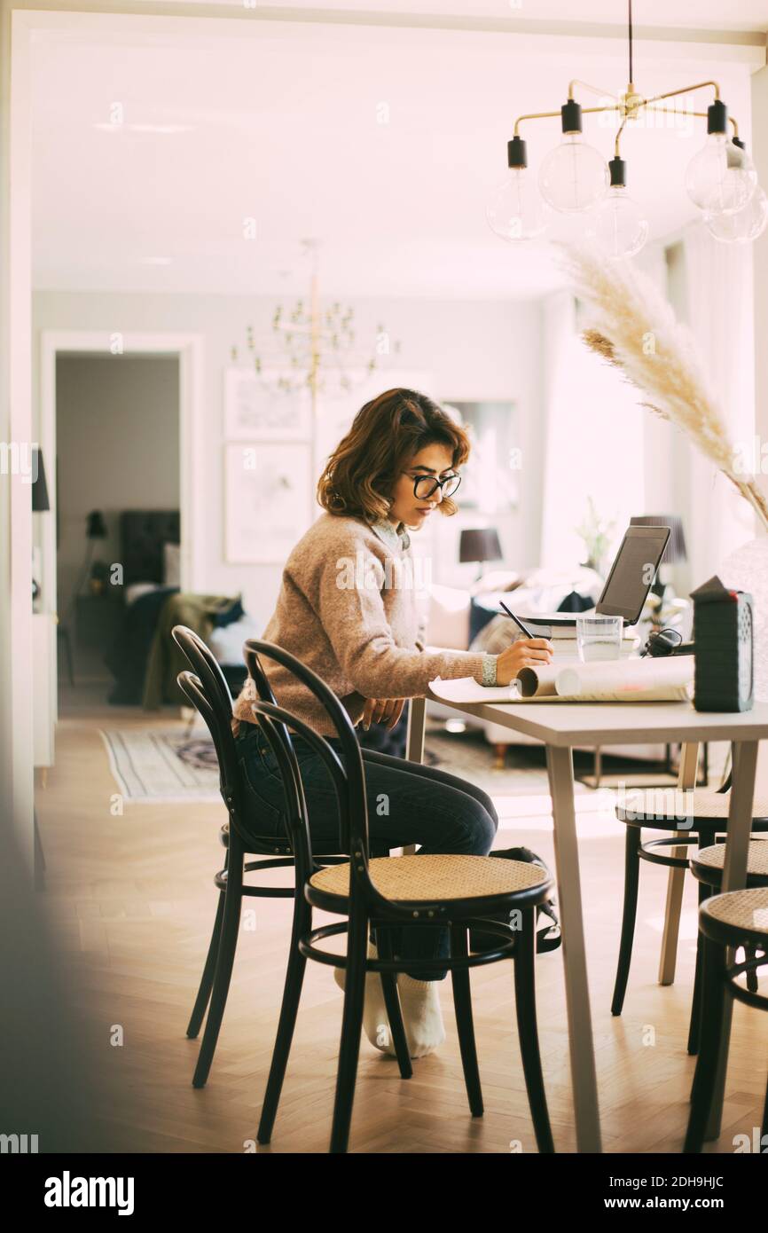 Woman working home sitting table hi-res stock photography and images ...