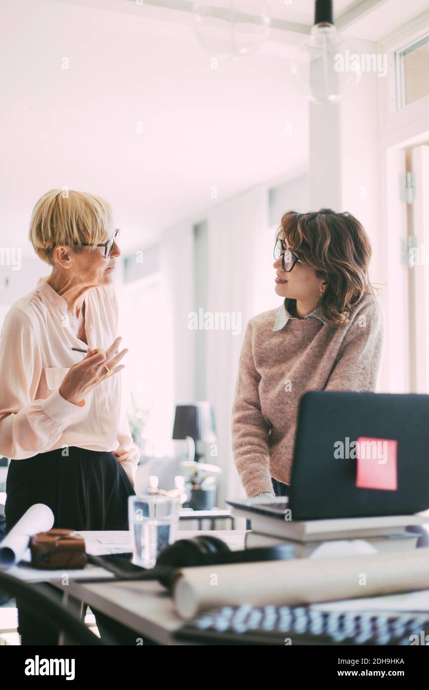 Two women having a discussion working at home Stock Photo - Alamy