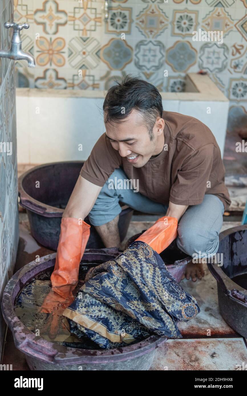 a portrait of man giving the water color to the batik cloth Stock Photo ...
