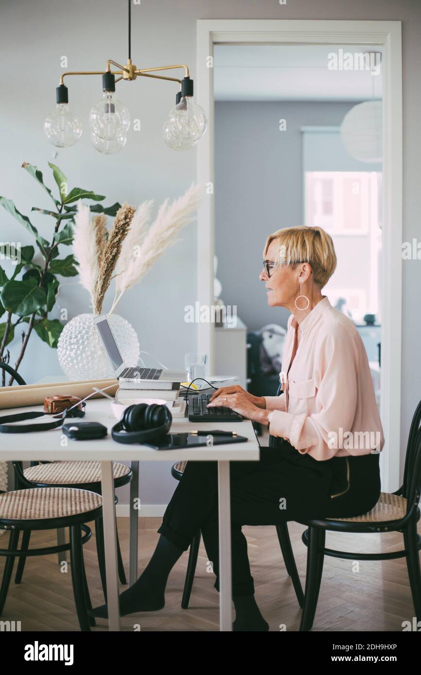 Woman working home sitting table hi-res stock photography and images ...