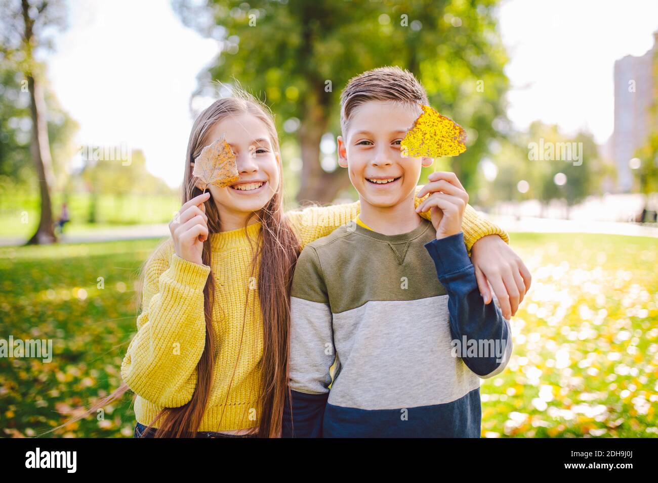 Friendship between siblings. Siblings together outside with bright ...