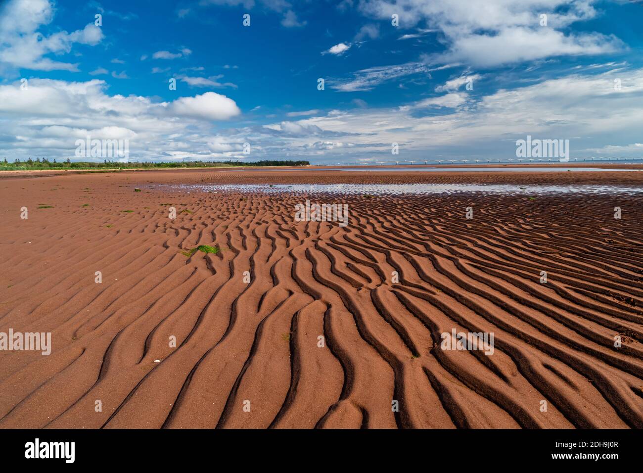 South shore Prince Edward Island beach with the Confederation Bridge at ...