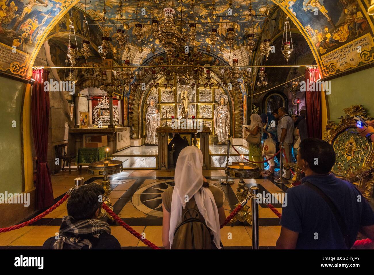 Tourists and pilgrims are praying at the altar Calvary, or Golgotha in ...