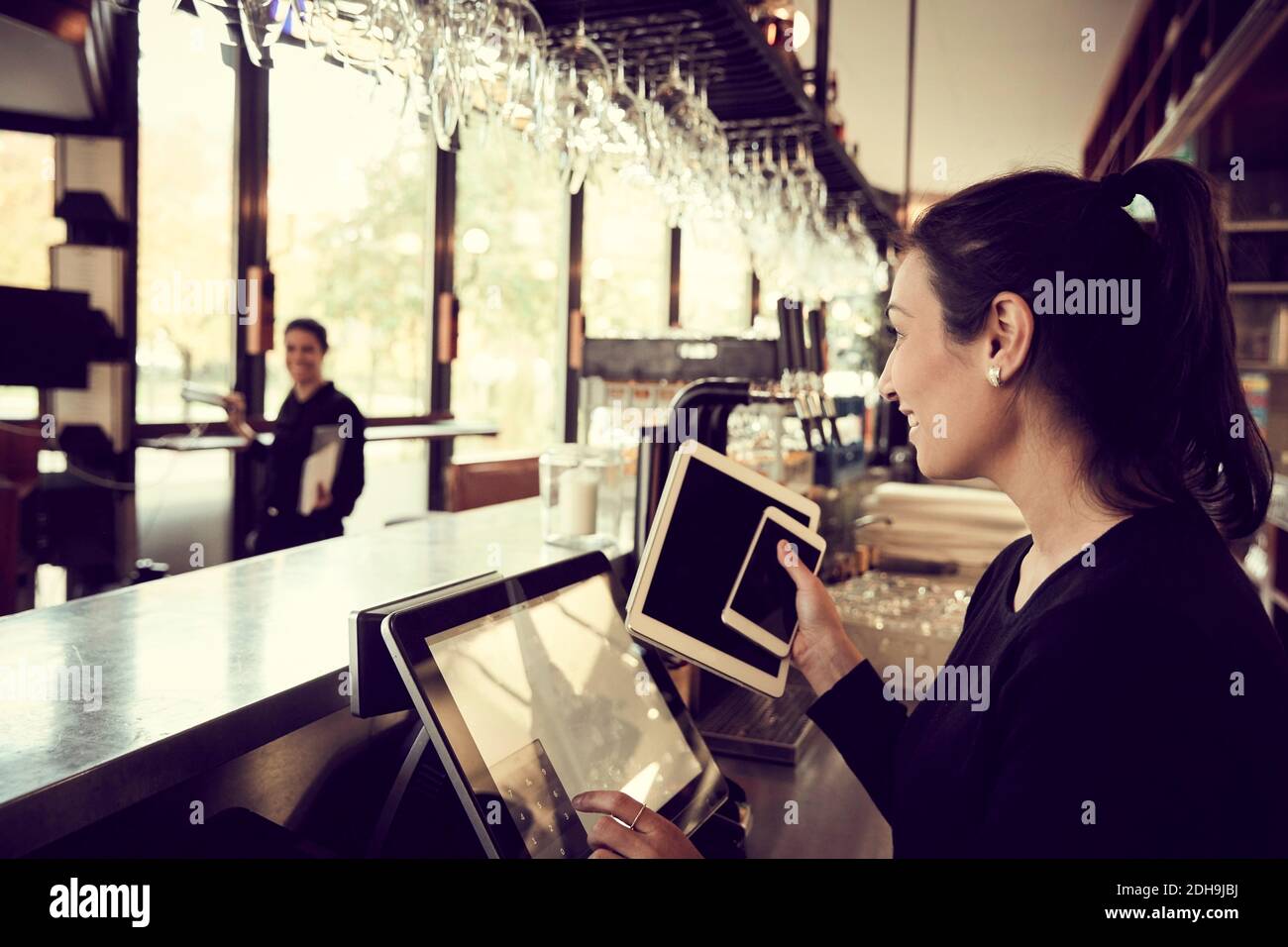Side view of coworker talking to owner in cafe Stock Photo - Alamy