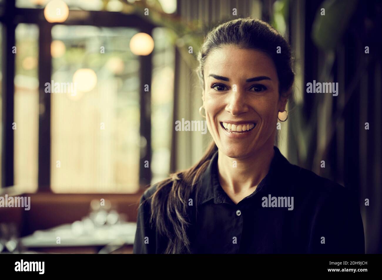 Portrait of happy owner standing in cafe Stock Photo - Alamy