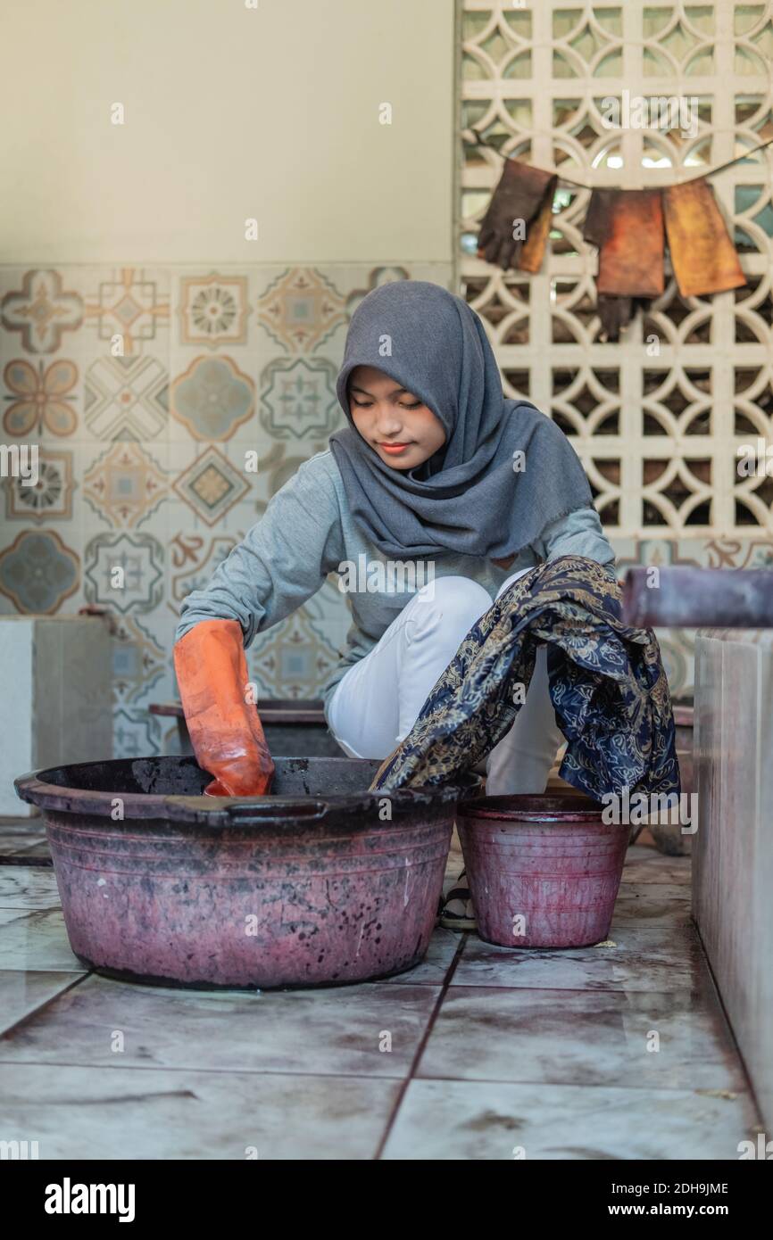 a portrait of a woman giving the water color to the batik cloth Stock ...