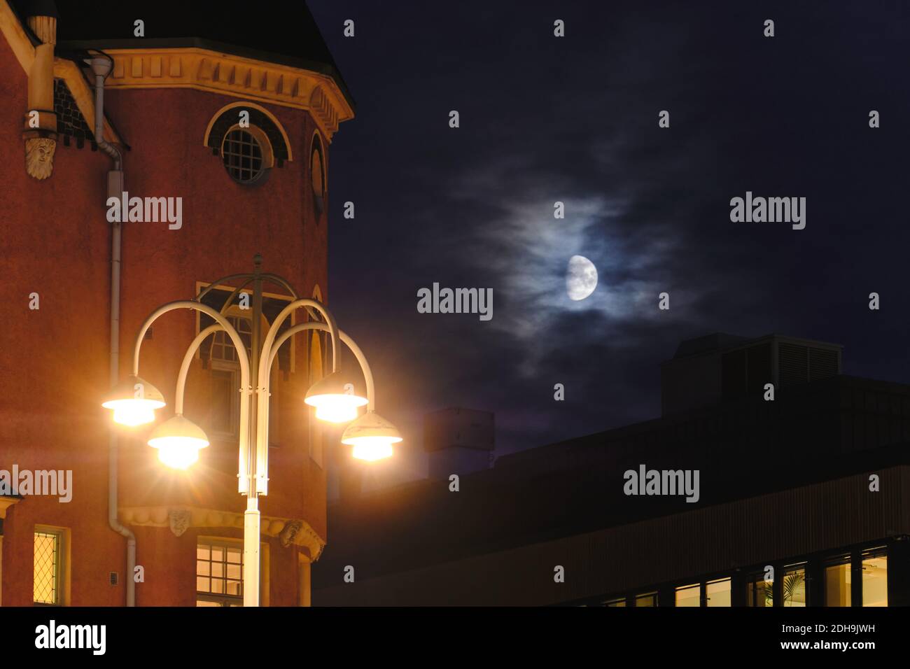 Night cityscape in an Old European City with the moon through the ...