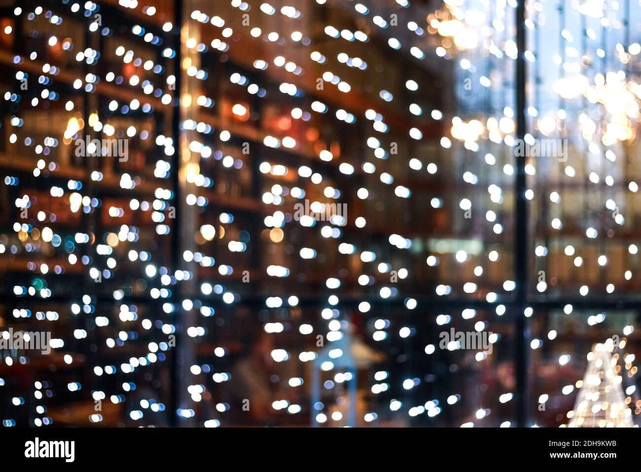 Blurry facade with garlands. Christmas lights in the windows. Bokeh ...