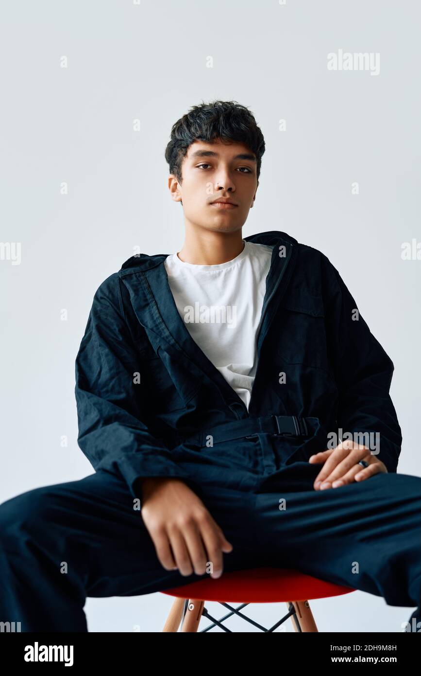 Stylish young man standing chair hi-res stock photography and images ...