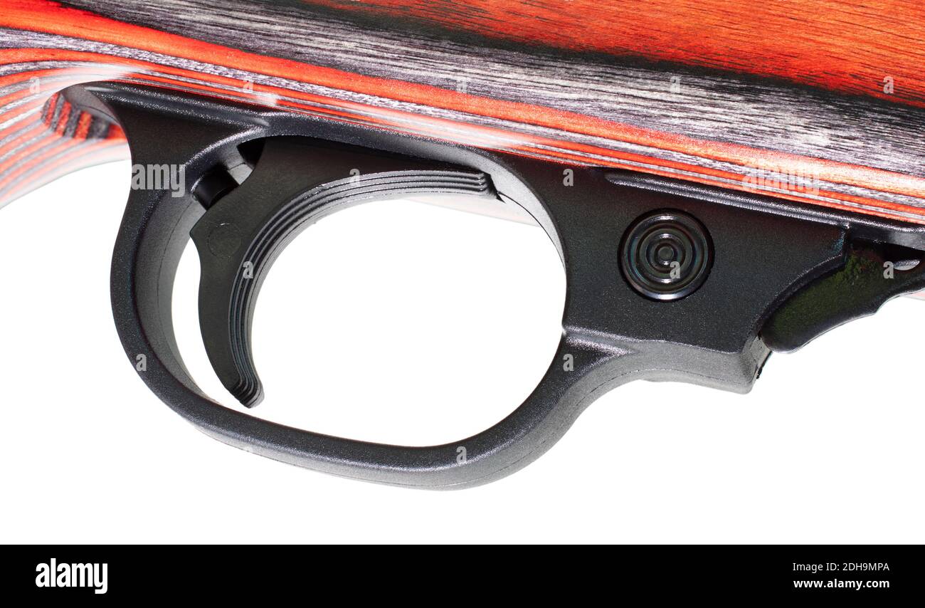 Safety button and trigger on a rifle with red and black wood laminated ...