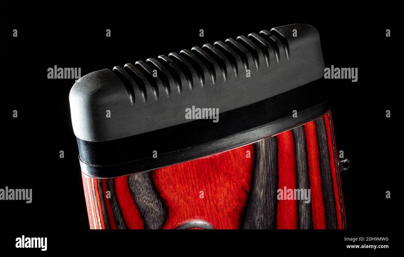 Rifle recoil pad attached to a red and black gun with a black ...