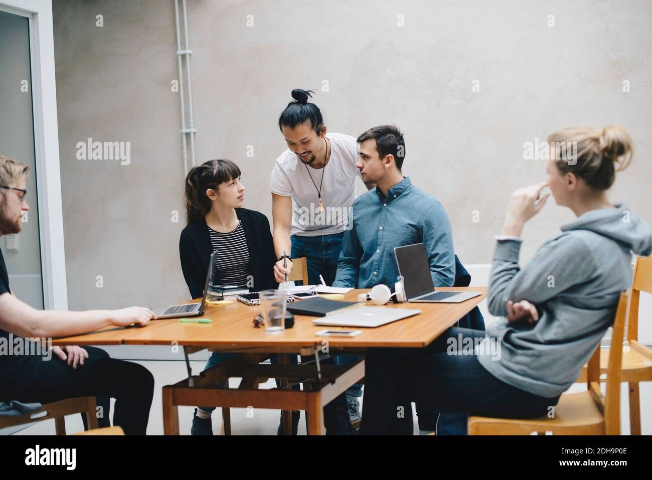 Multi-ethnic computer programmers working at desk in office Stock Photo ...