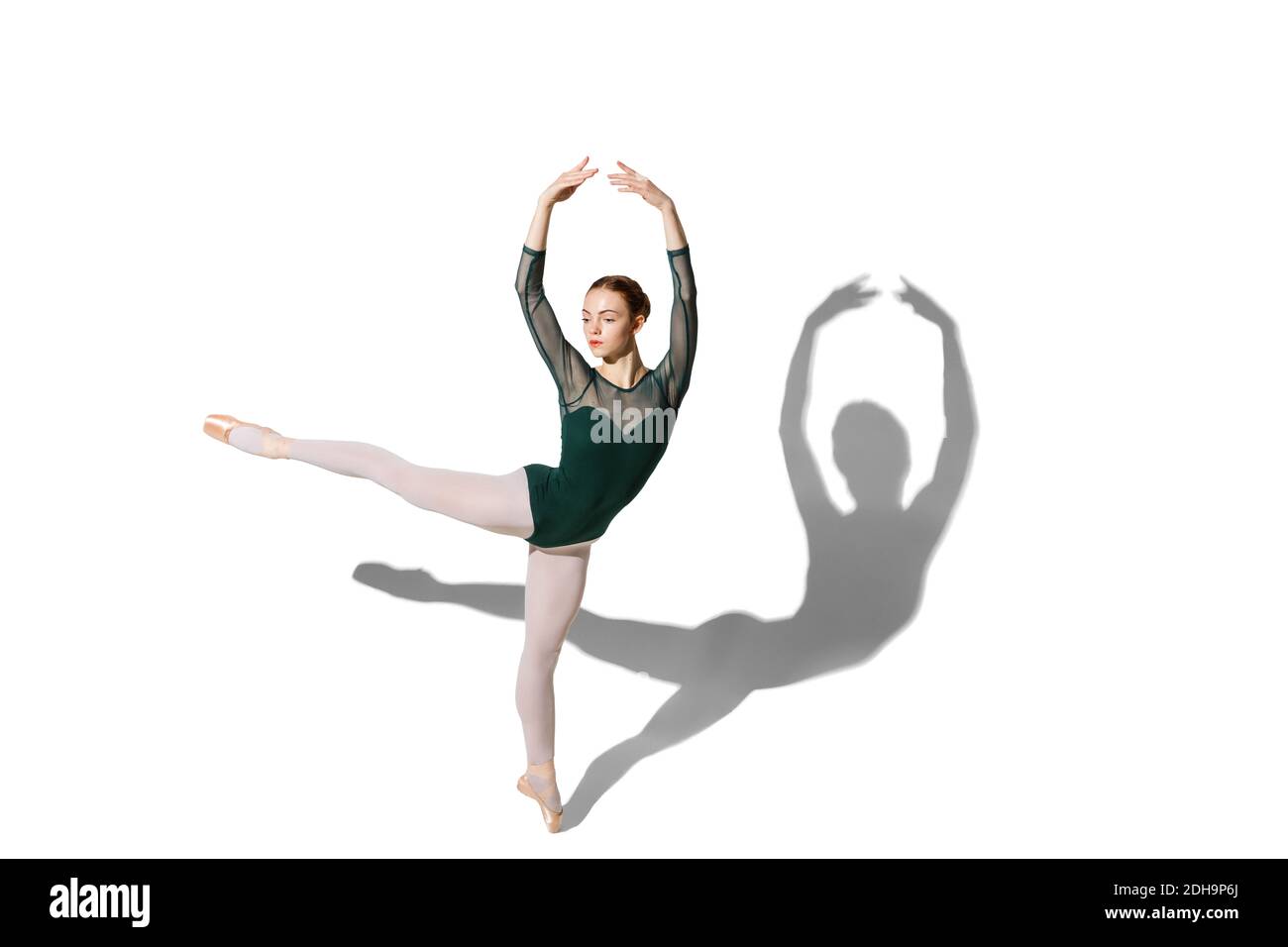 Beautiful young girl ballet dancer isolated over white background with ...