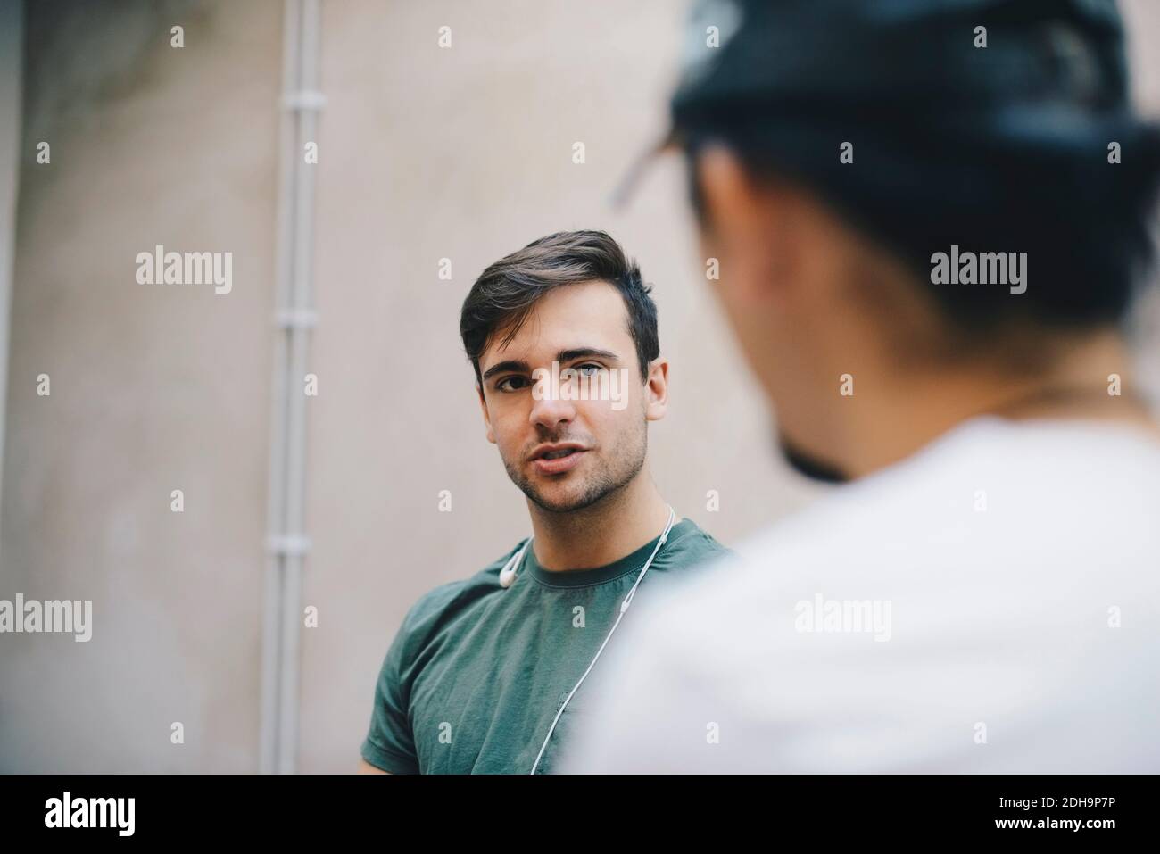 Male computer programmer talking to male colleague in office Stock ...