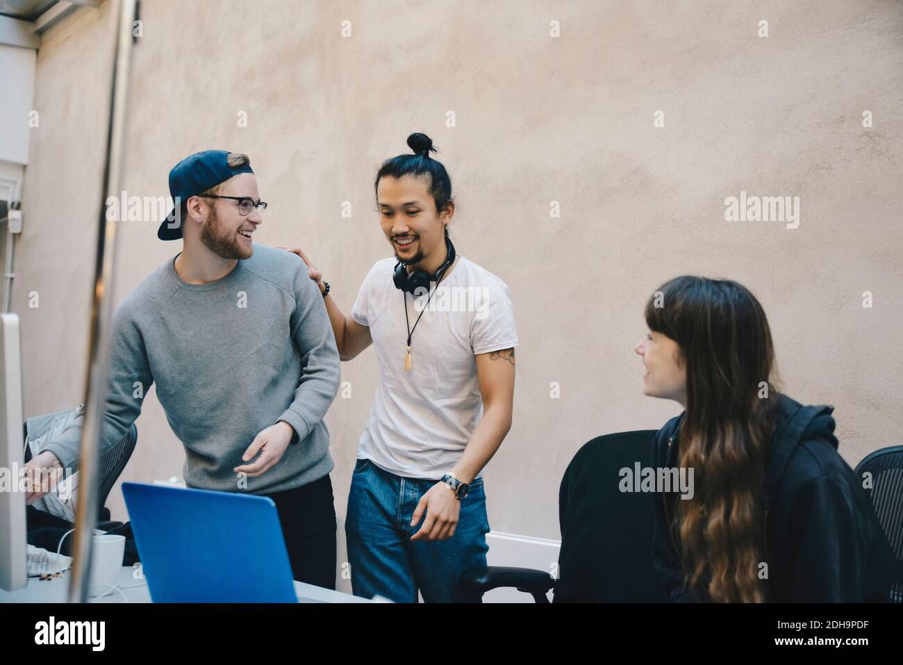 Happy male and female computer programmers in office Stock Photo - Alamy