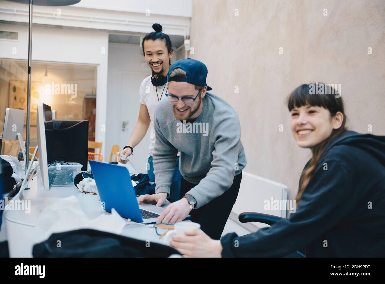 Happy male and female computer programmers at desk in office Stock ...