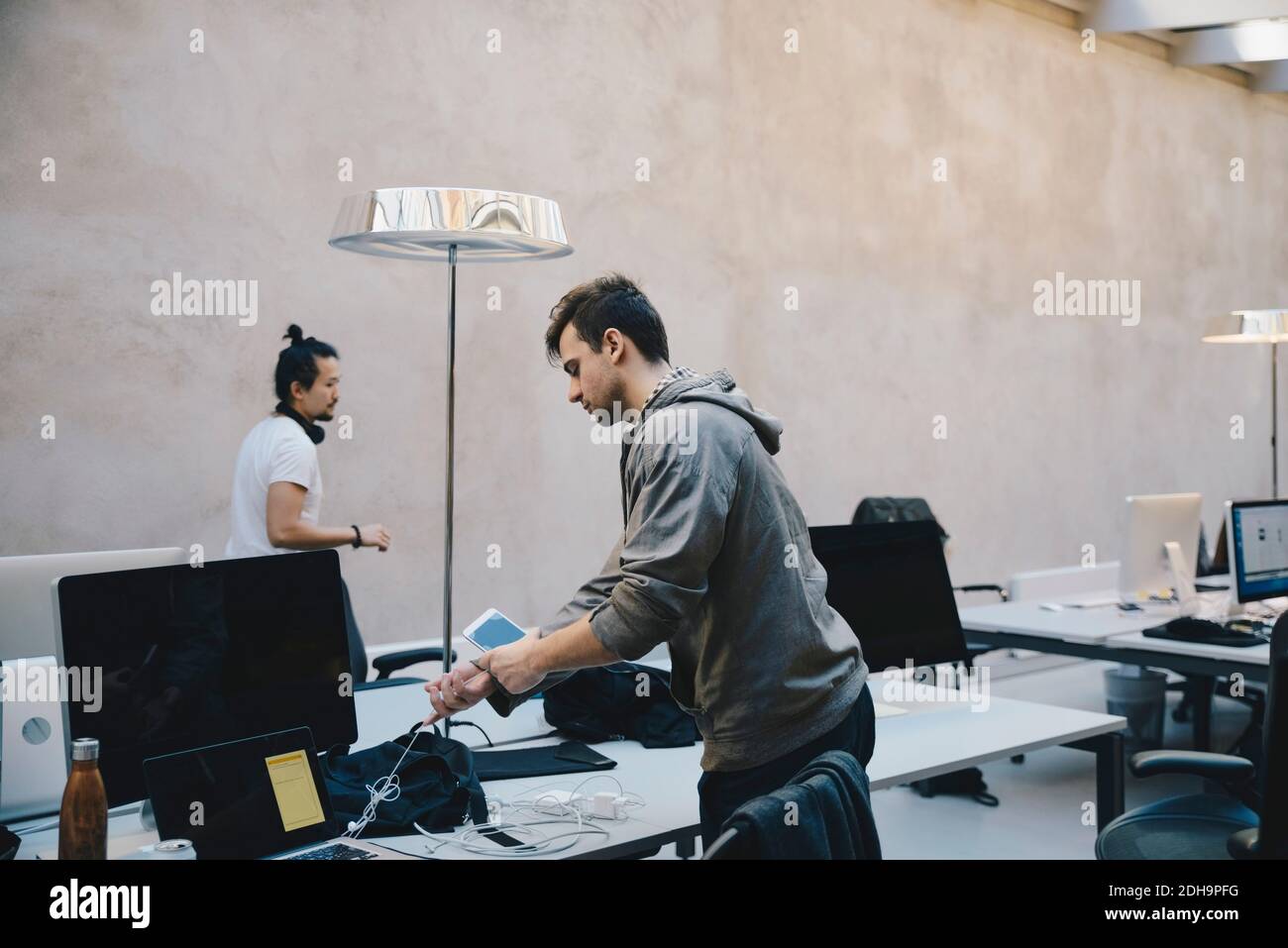 Side view of male computer programmers working in creative office Stock ...