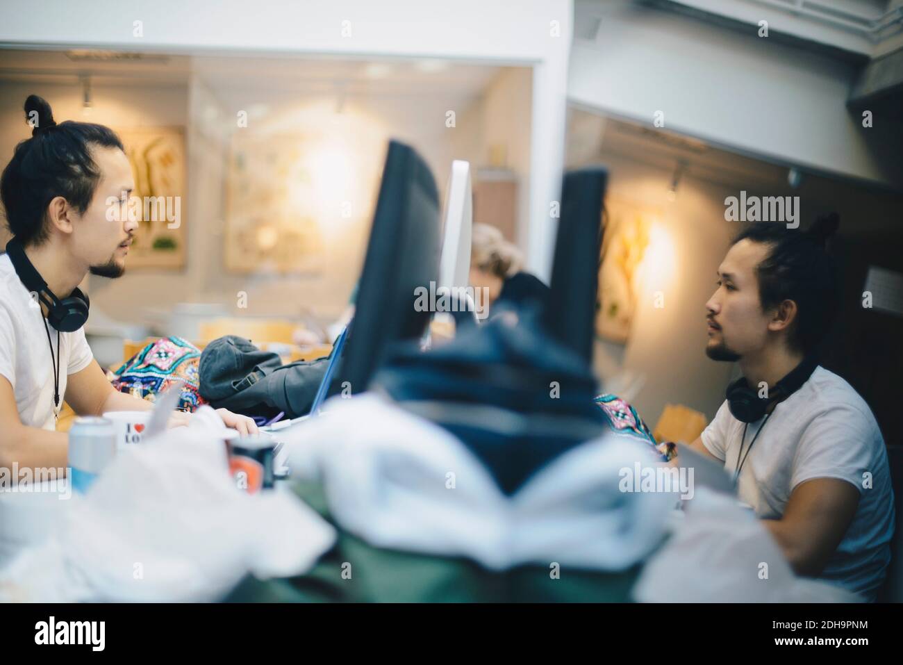 Side view of male programmer working on computer in office Stock Photo ...
