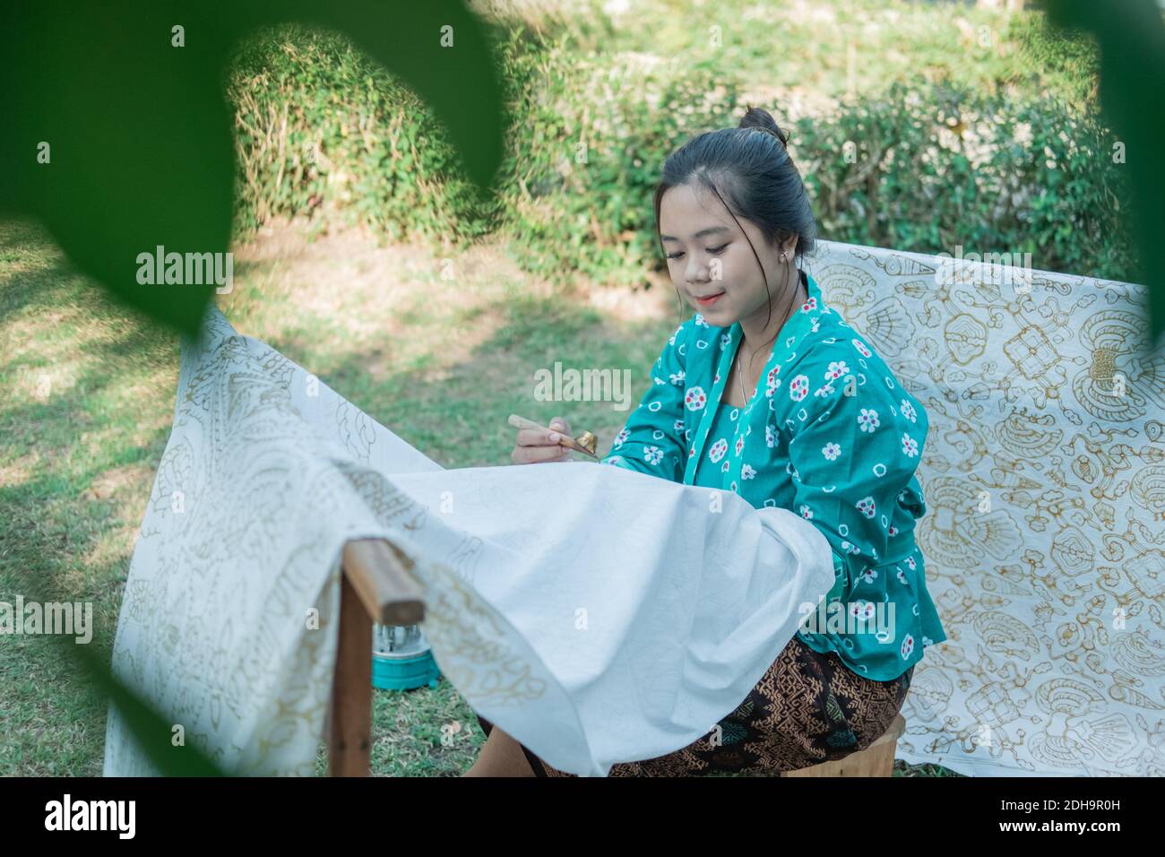 portrait young woman drawing handmade traditional batik pattern in the ...