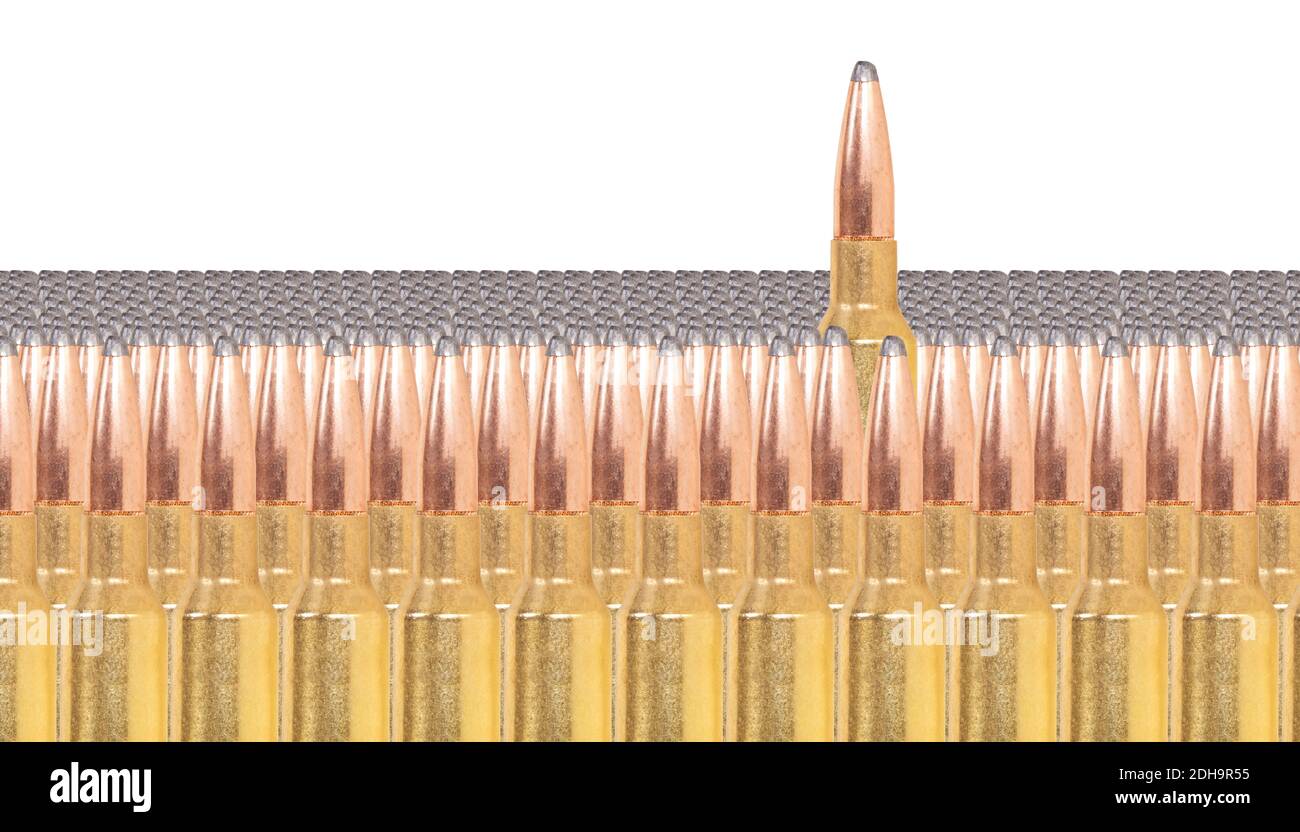 One single bullet rising above the other rifle cartridges on white ...