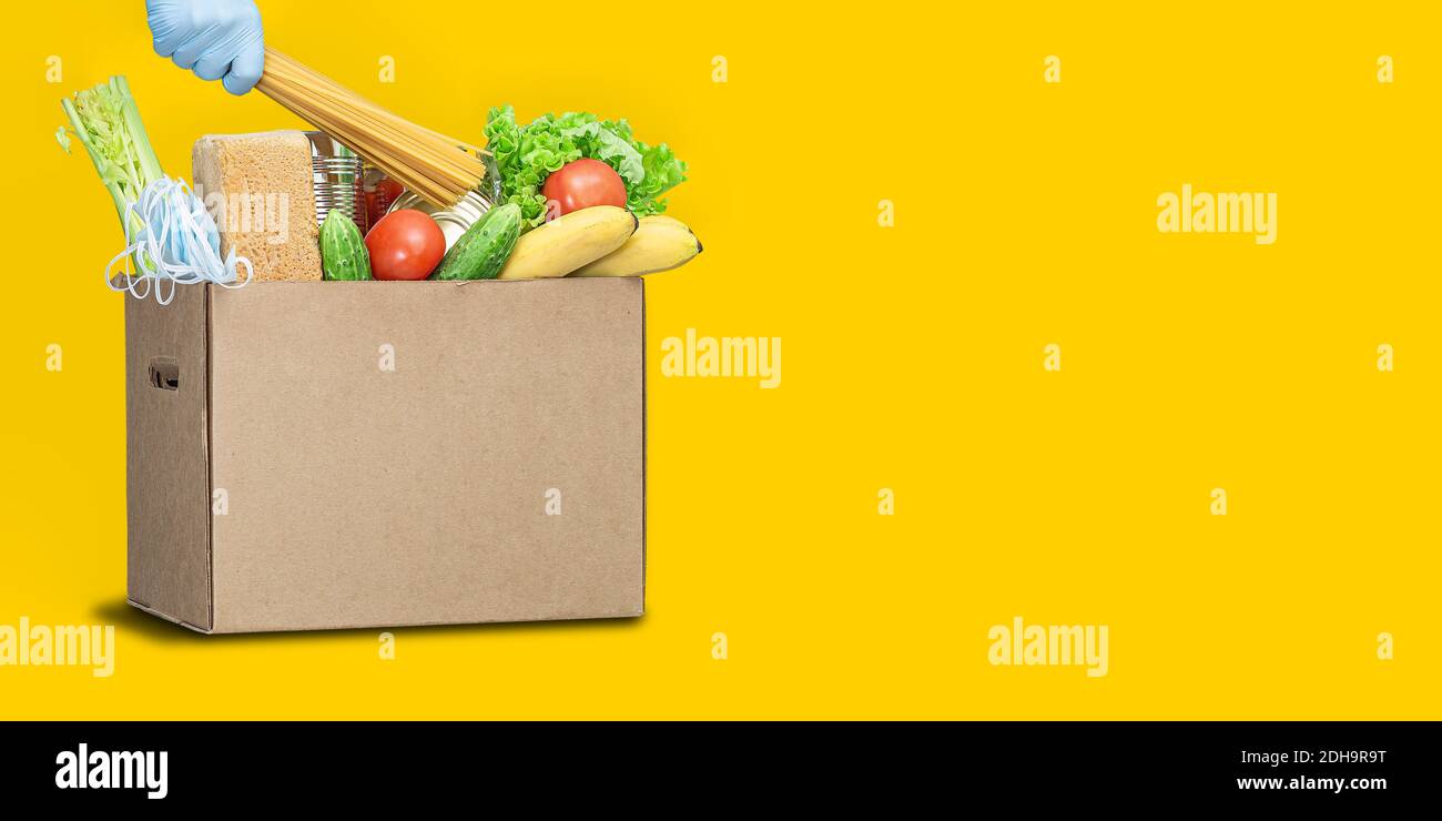 Donation box with food on a yellow background. Coronavirus food ...