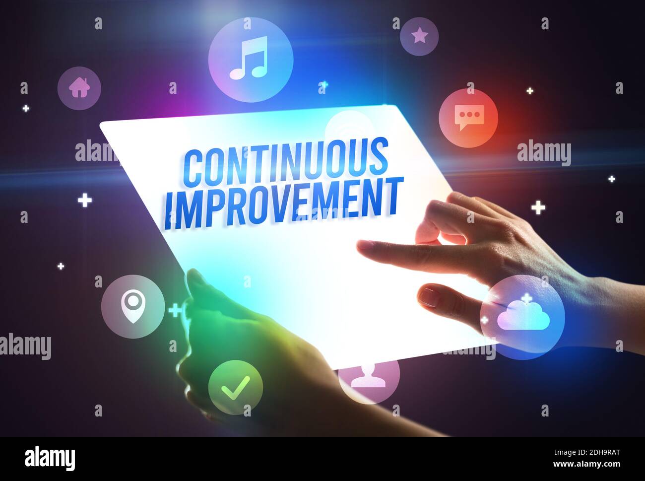 Holding futuristic tablet with CONTINUOUS IMPROVEMENT inscription, new ...