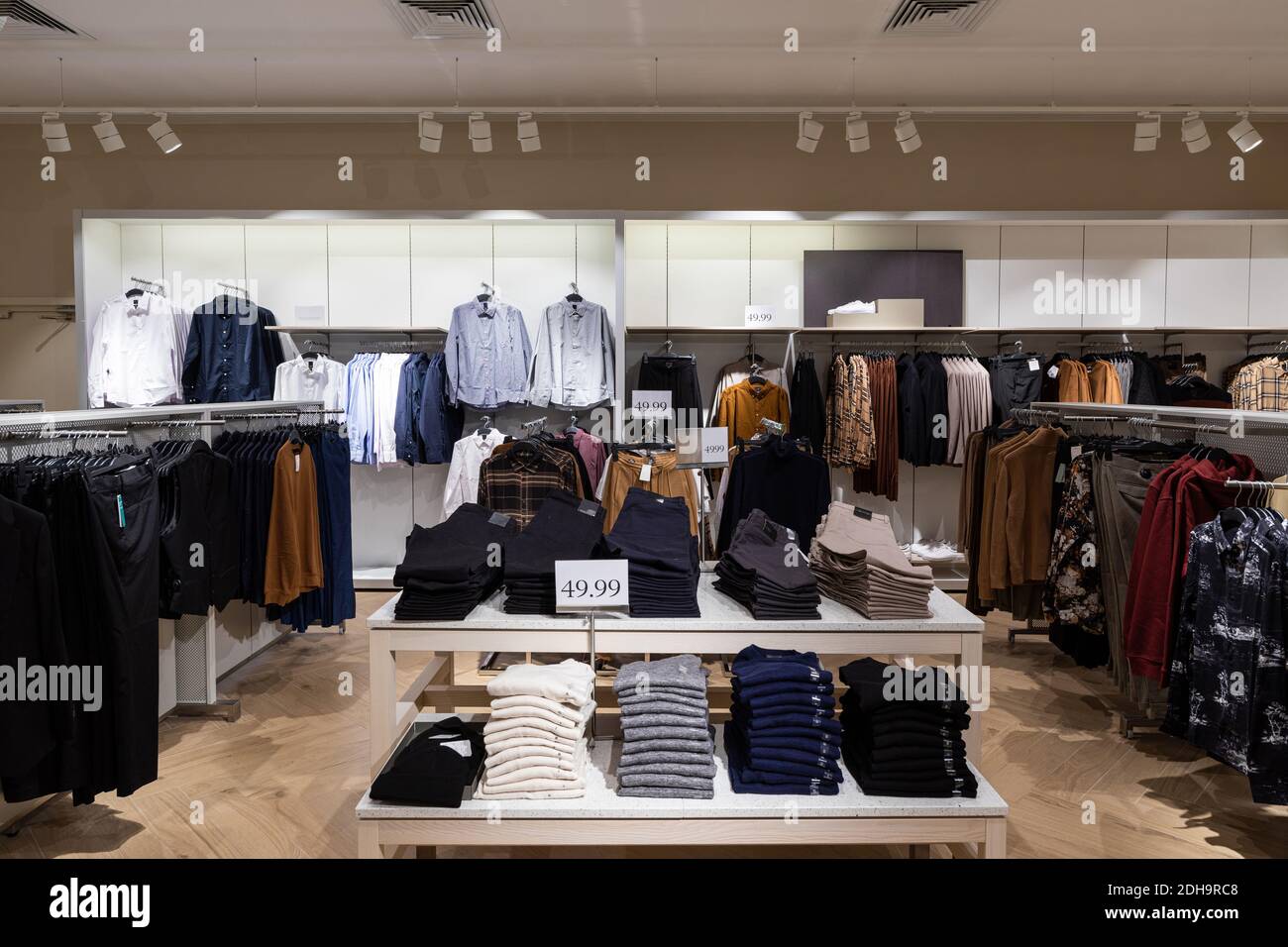 clothes in interior of fashion shop Stock Photo - Alamy