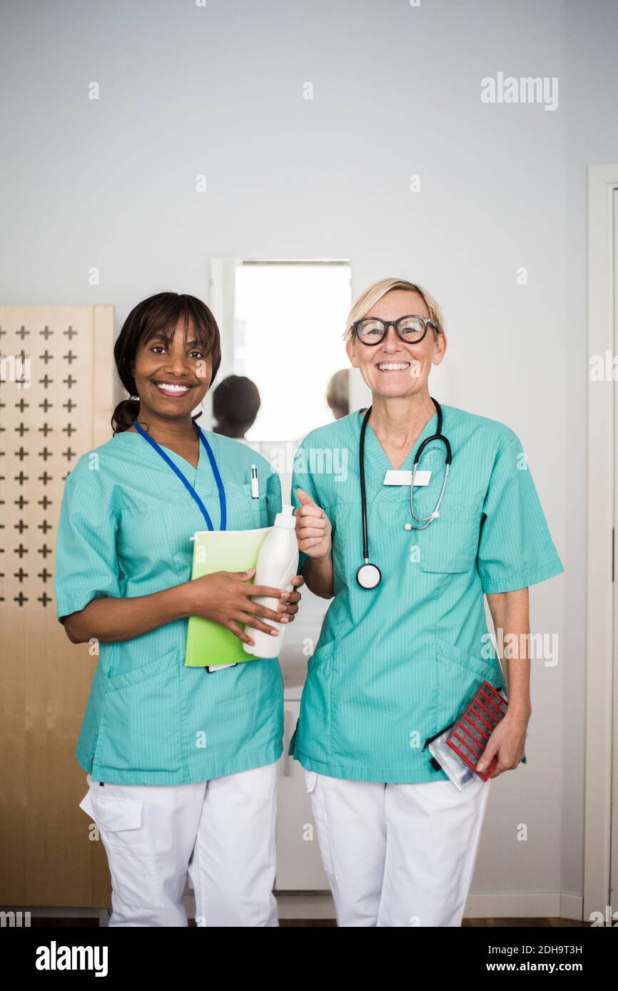 Portrait of smiling female healthcare workers standing in clinic Stock ...