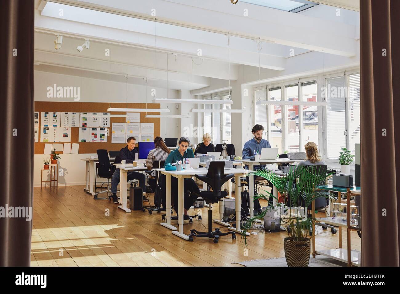 Professionals working in creative office Stock Photo - Alamy