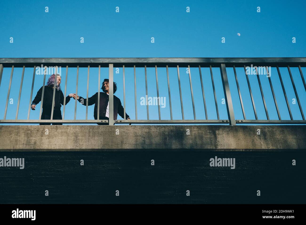 Two friends talking on bridge hi-res stock photography and images - Alamy