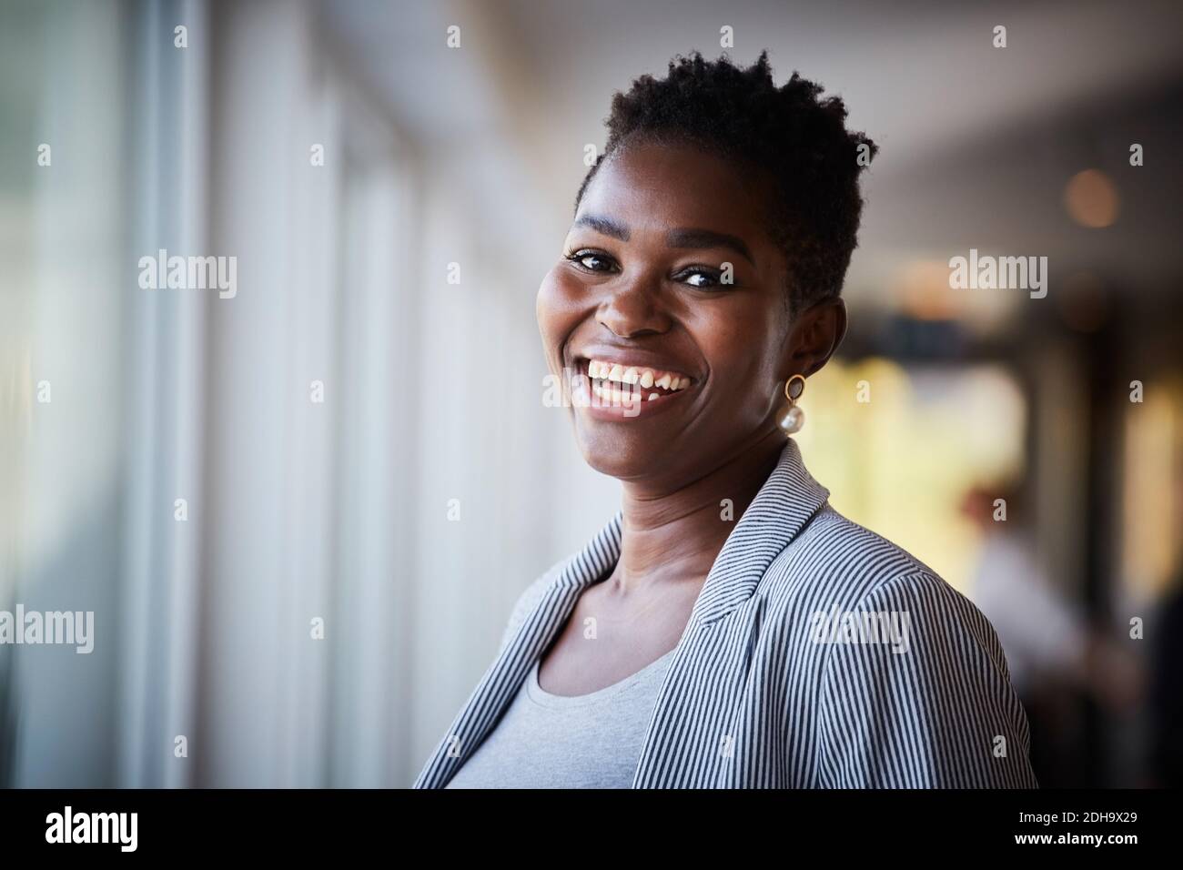 Portrait of confident female entrepreneur standing at workplace Stock ...