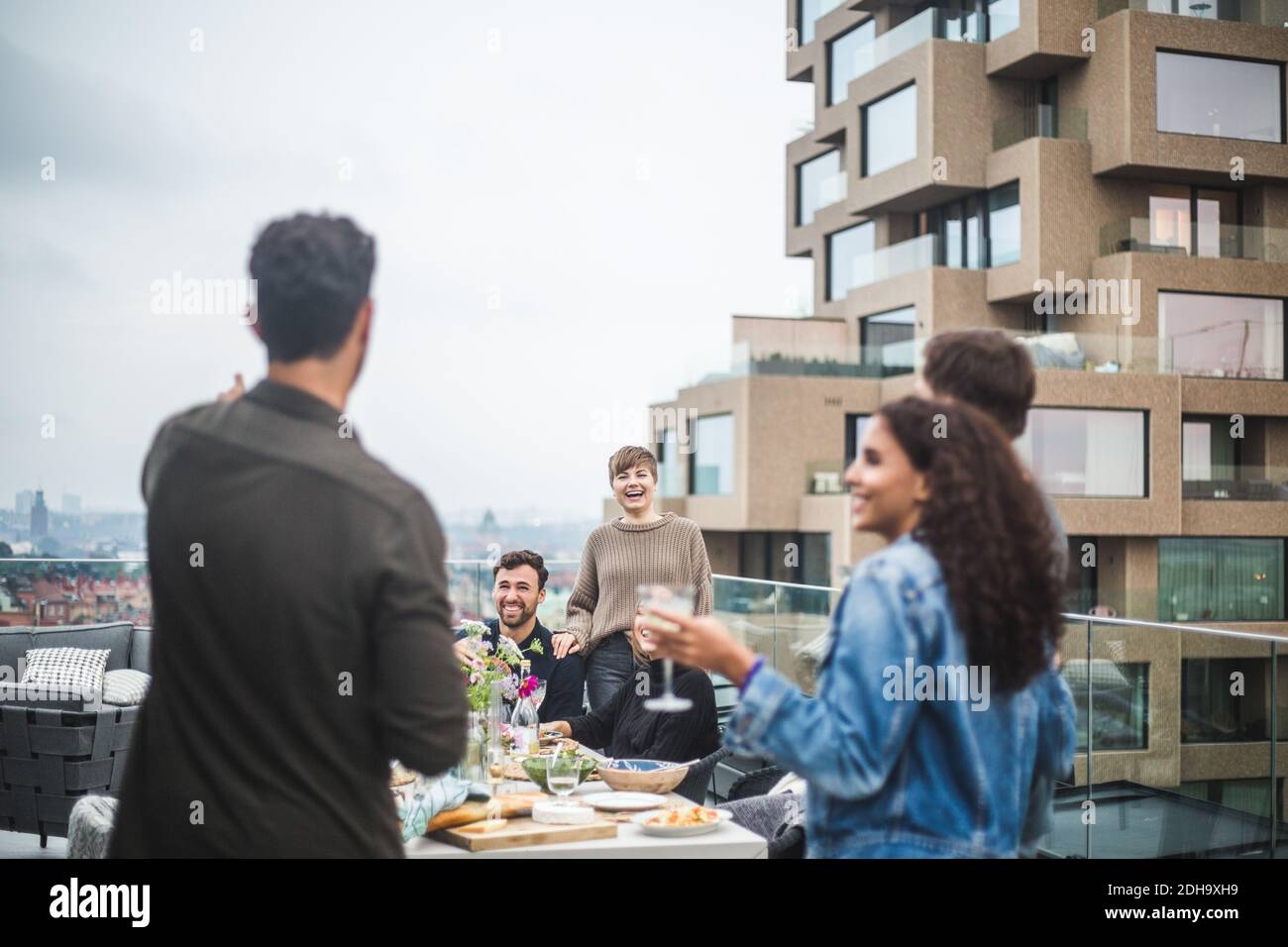 Young friends enjoying during social gathering on rooftop Stock Photo ...