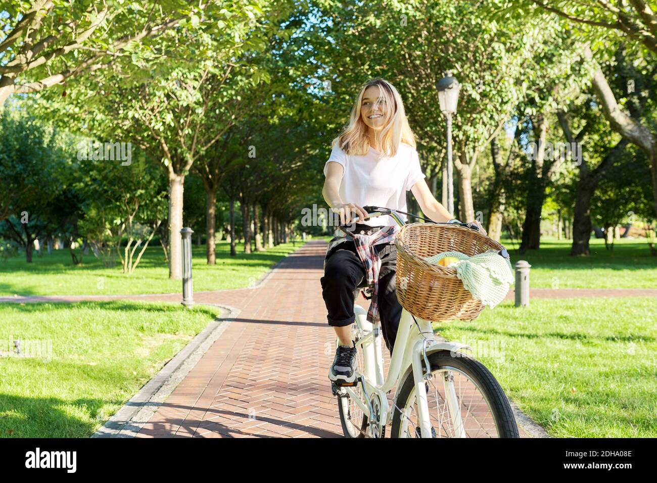 Young beautiful woman on vintage bike with basket rides on nature Stock ...
