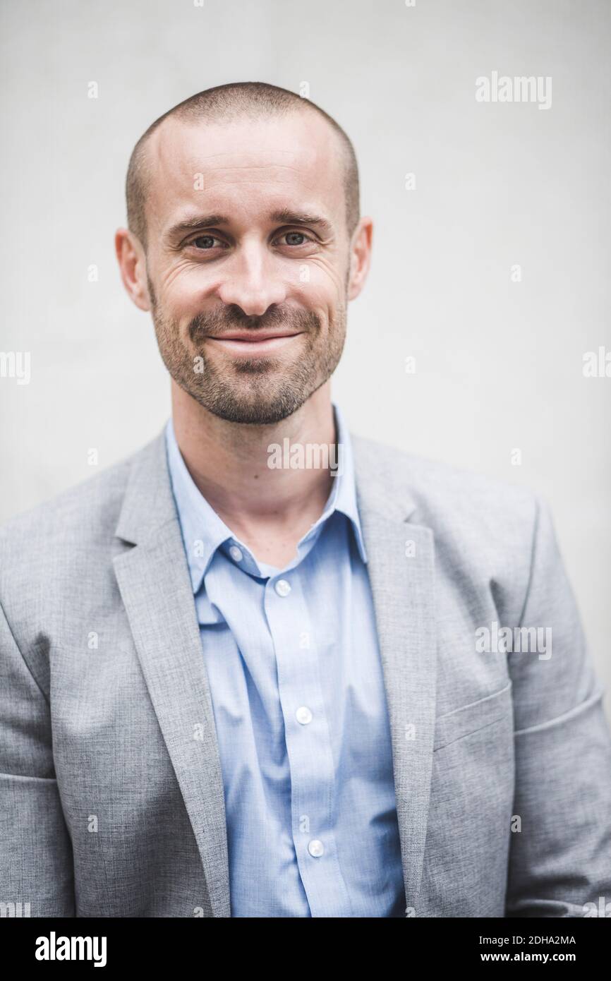 Businessman smiling standing against hi-res stock photography and ...