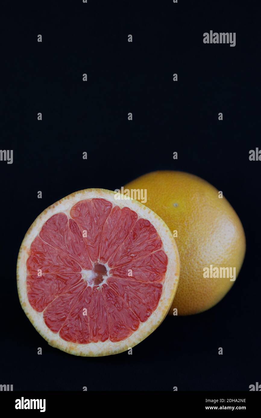 Two grapefruits against black background with copy space Stock Photo ...