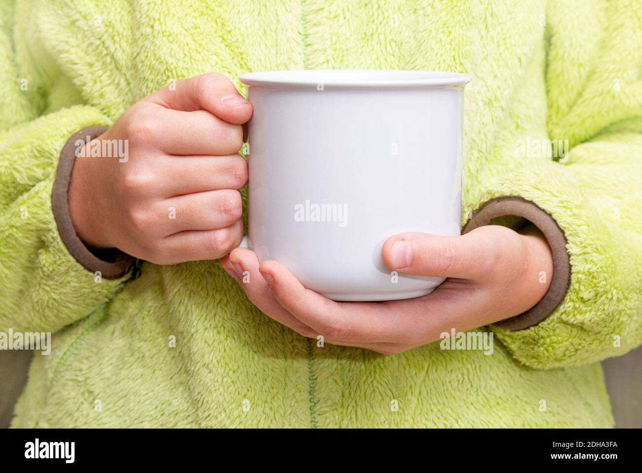 Girl is holding white cup in hands. Mockup for designs Stock Photo - Alamy