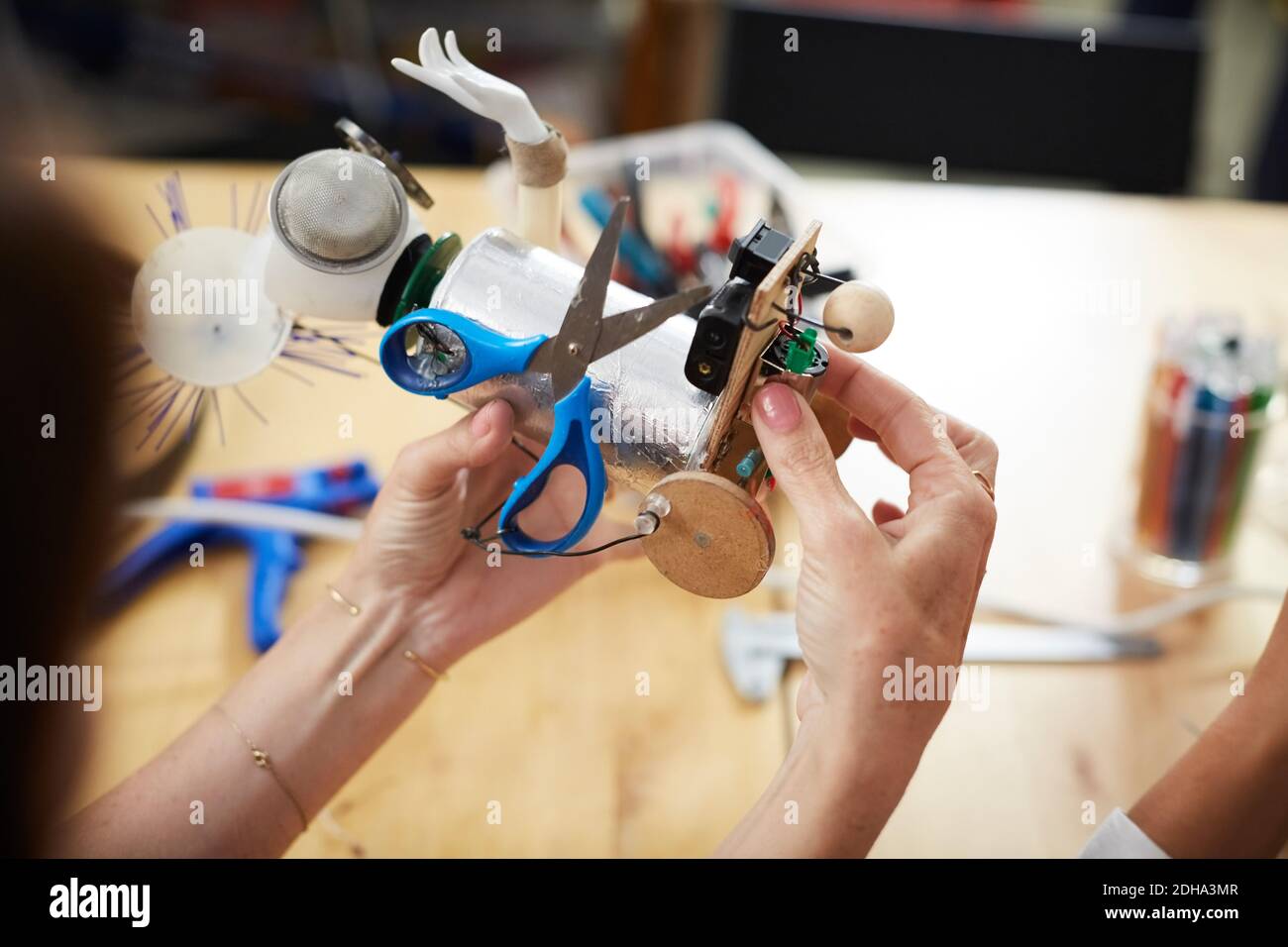 High angle view of female engineers making robot model at workshop ...