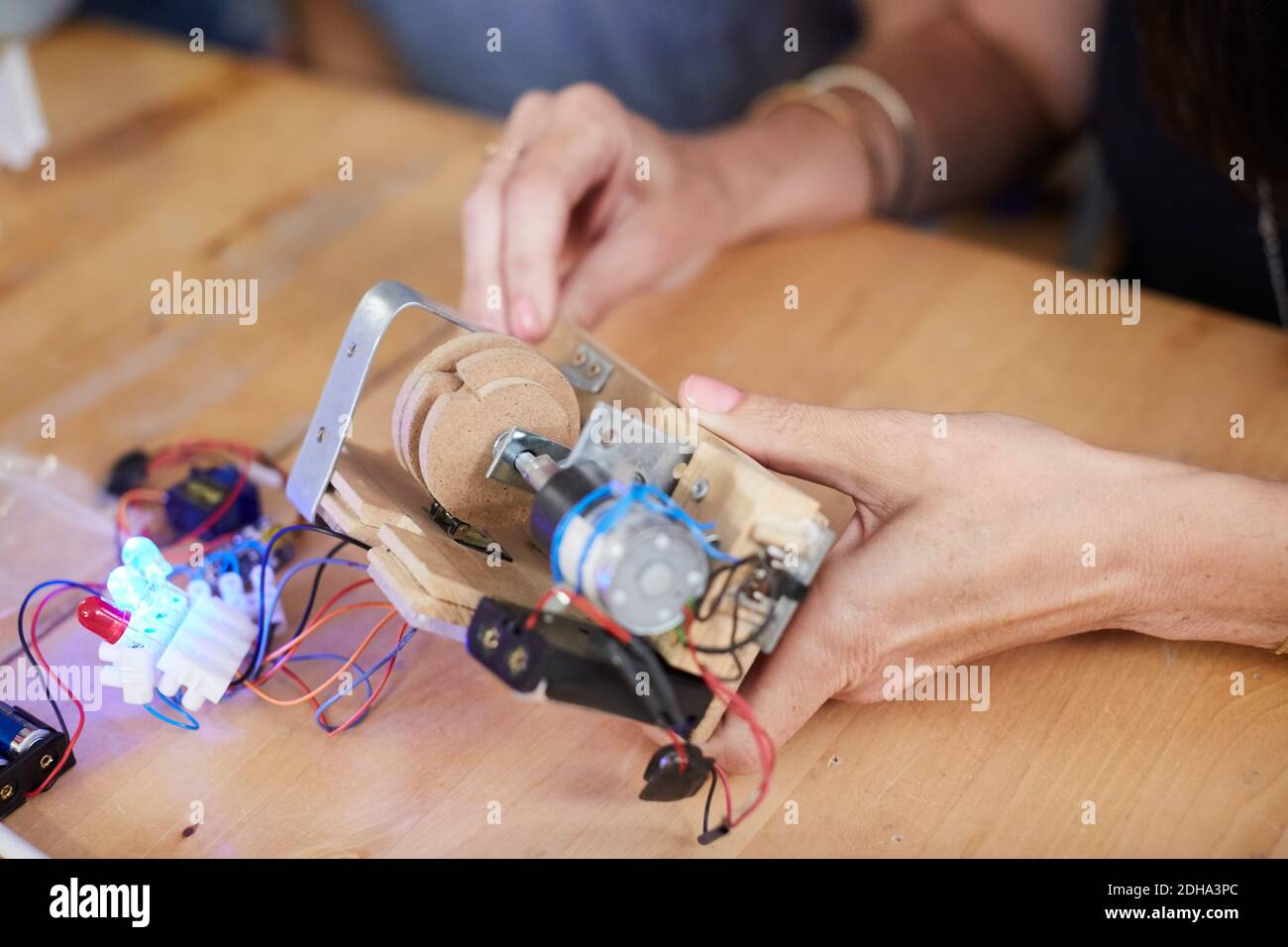 Cropped hands of mature female inventor making model at workshop Stock ...