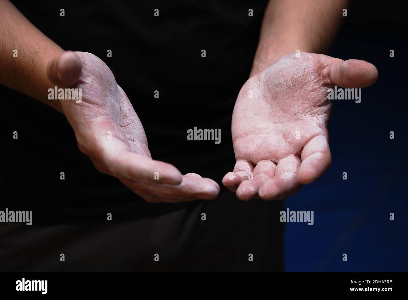 Male hands smeared with magnesium powder ready to workout. Close up ...