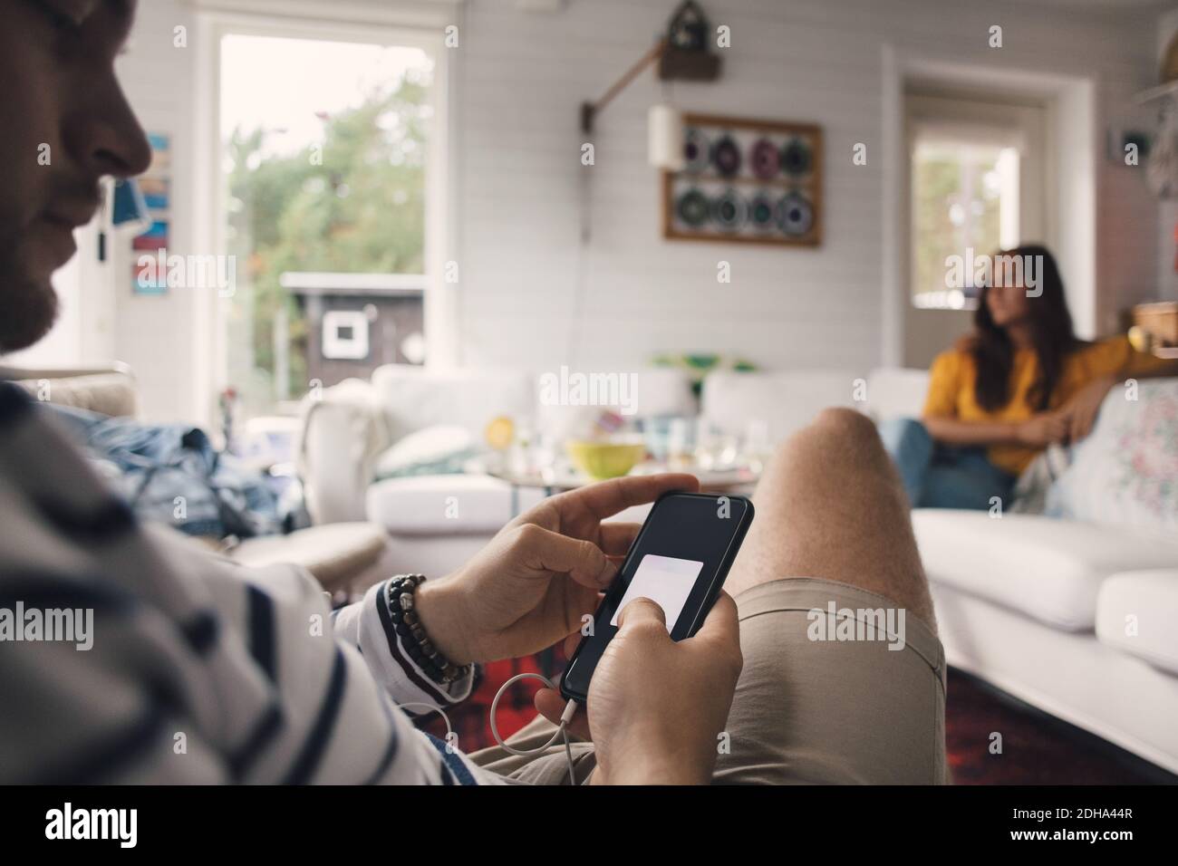 Man using mobile sitting on sofa hi-res stock photography and images ...