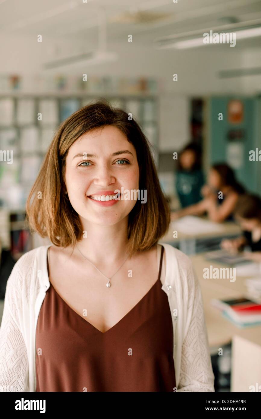 Portrait of a smiling female student standing in the library Stock ...