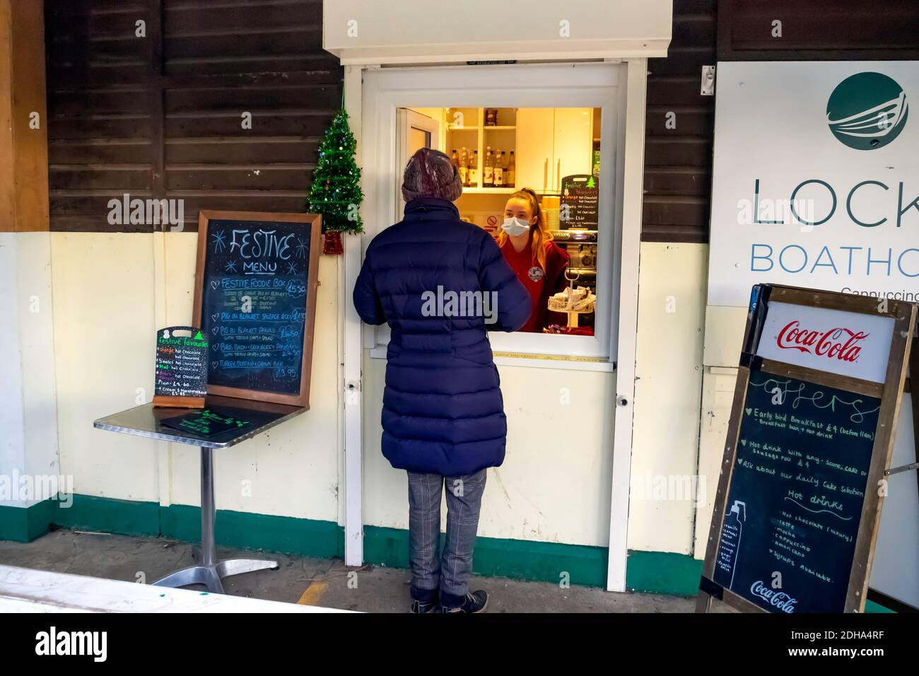 A senior woman buying refreshments from a café in Locke Park Redcar ...
