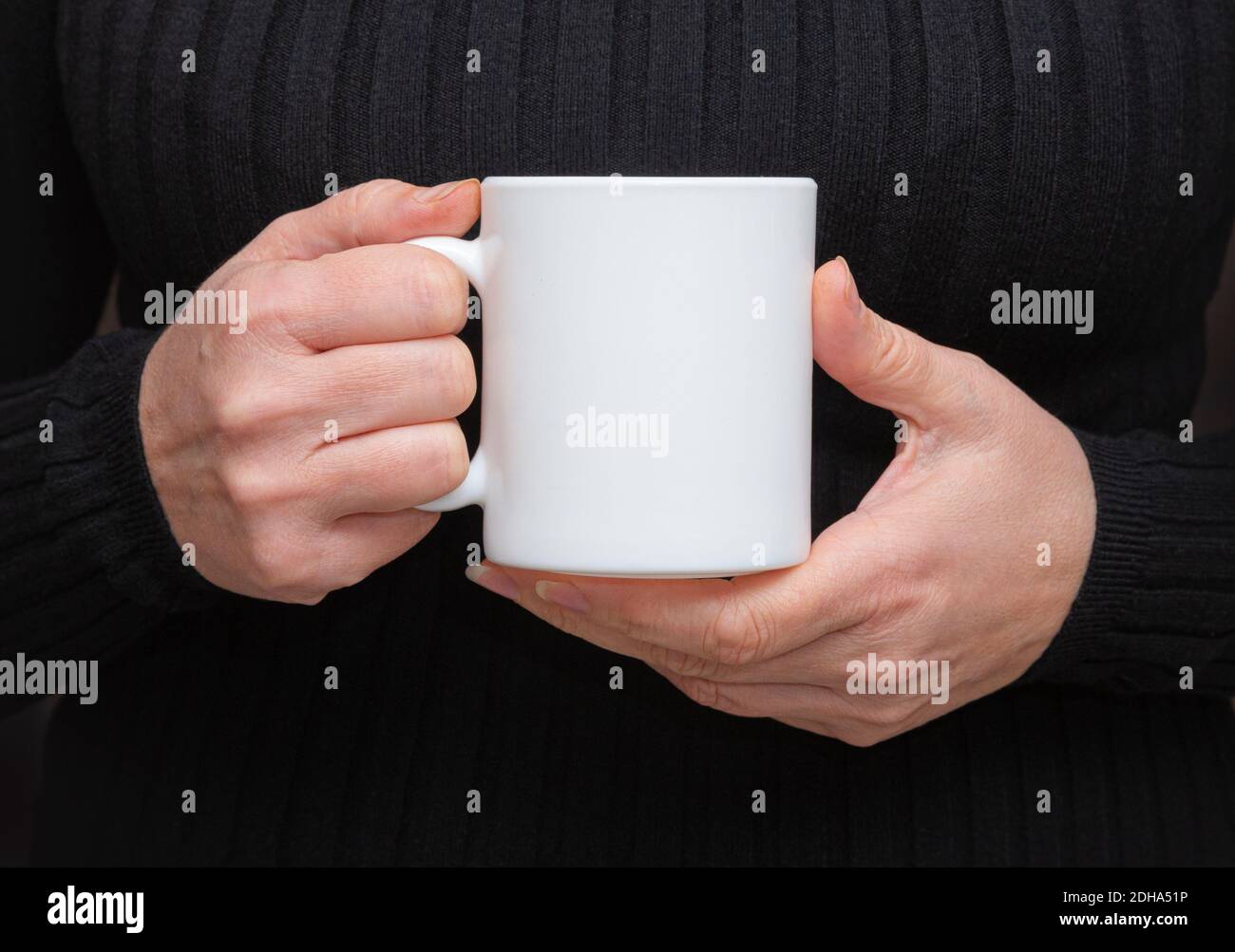 Girl is holding white cup in hands. Mockup for designs Stock Photo - Alamy