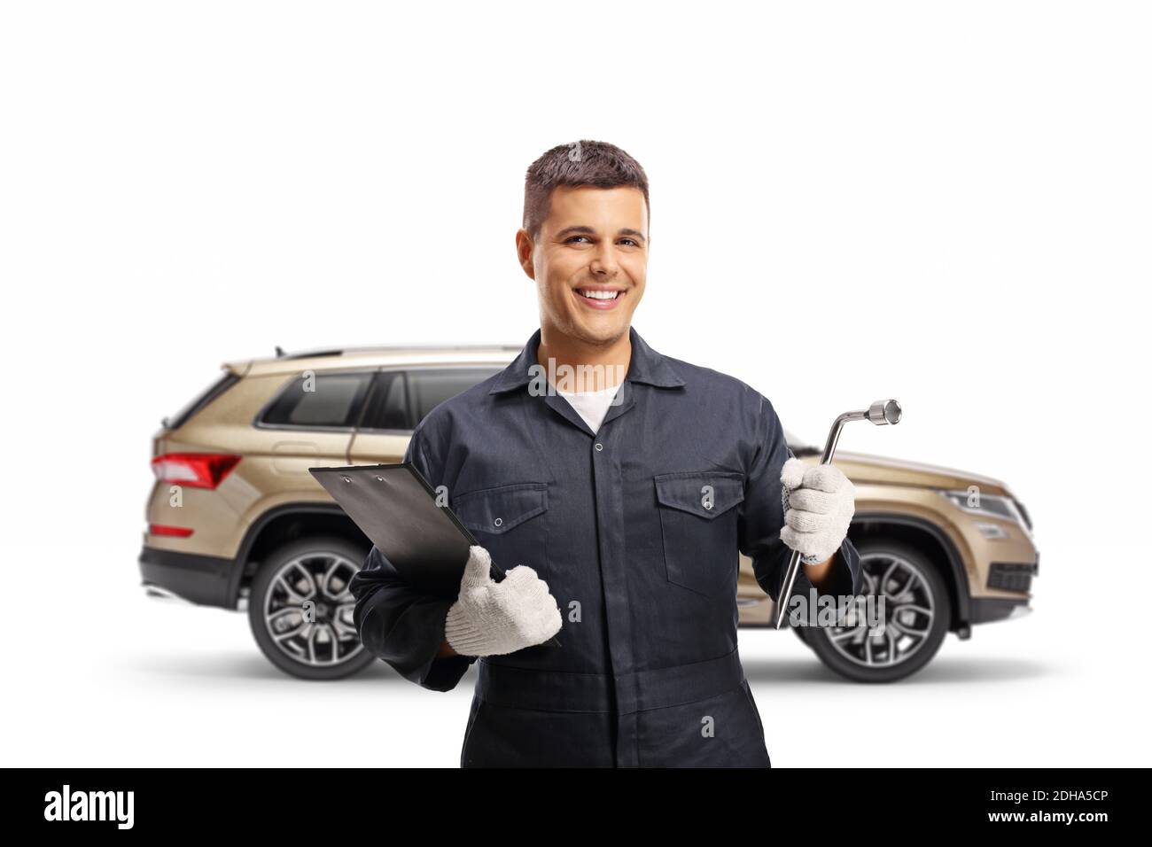 Auto repair mechanic worker with a SUV holding tools and a clipboard ...