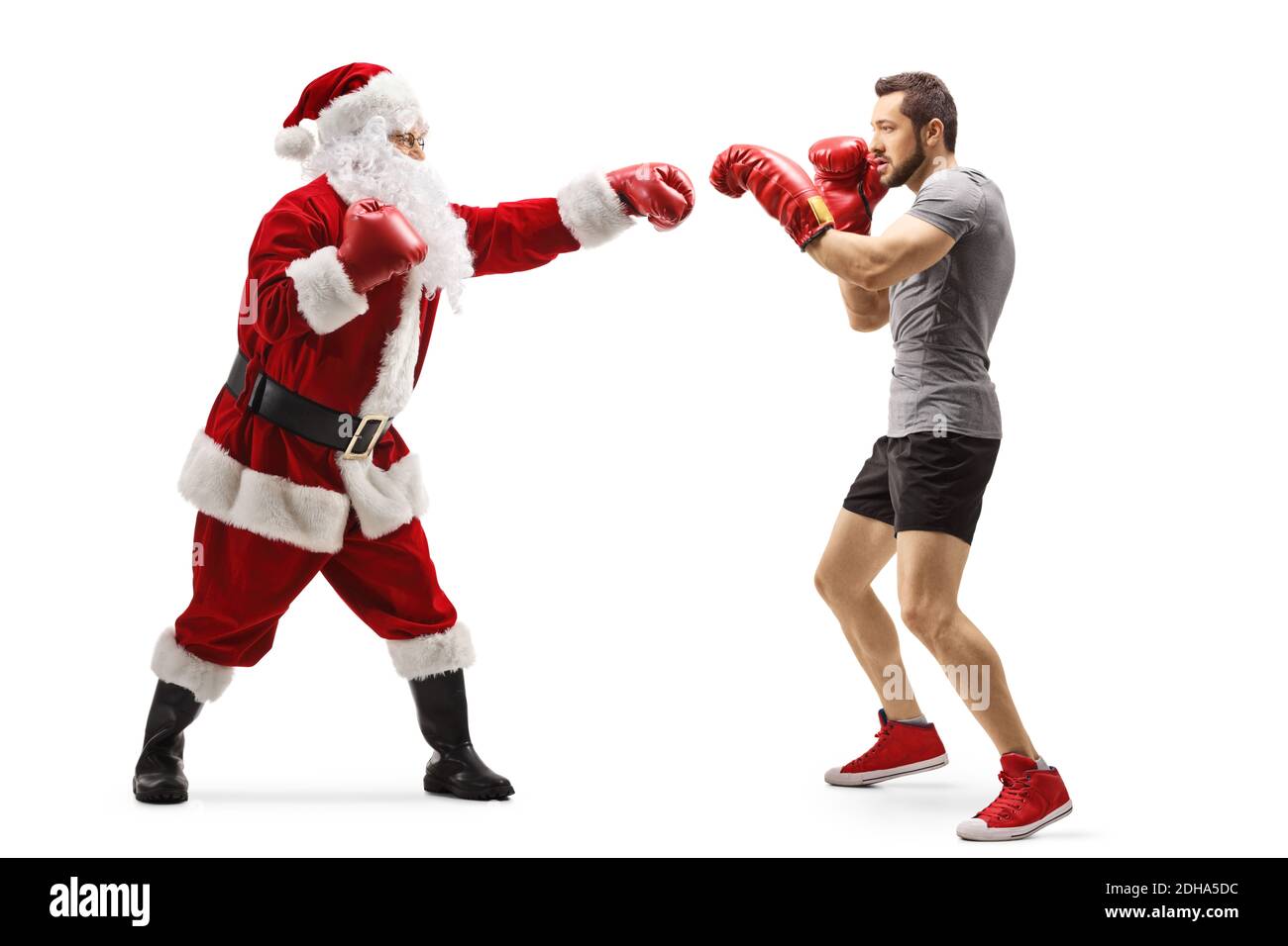 Full length profile shot of a man boxer and santa claus fighting with ...