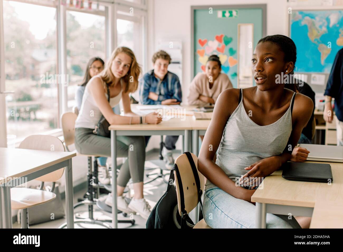 Teenage students sitting in classroom Stock Photo - Alamy