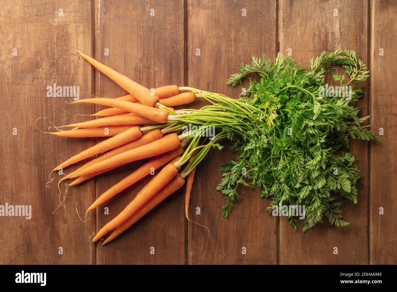 Fresh organic raw carrots on a dark rustic wooden background, shot form ...