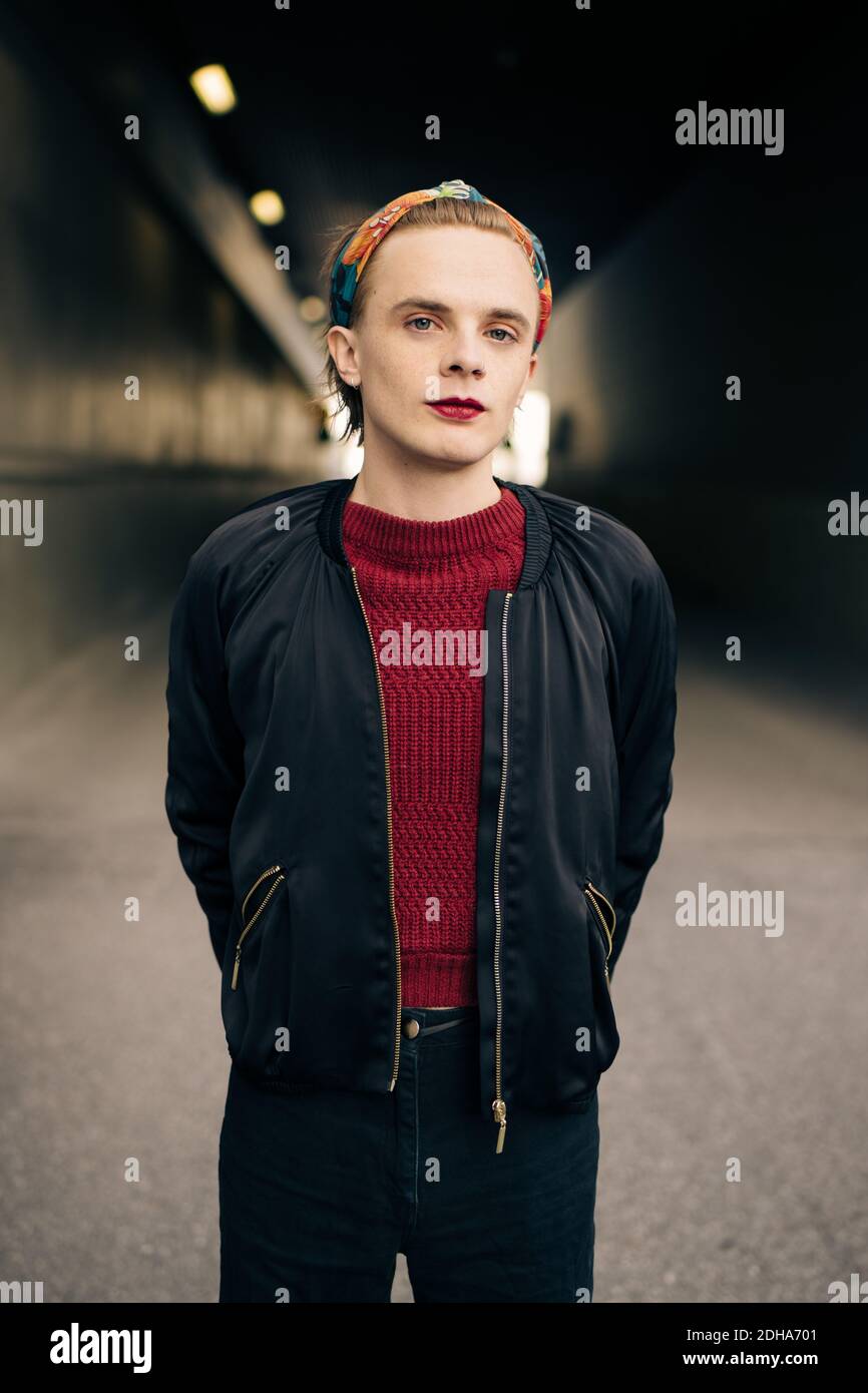 Portrait of man with hands behind back standing in corridor Stock Photo ...