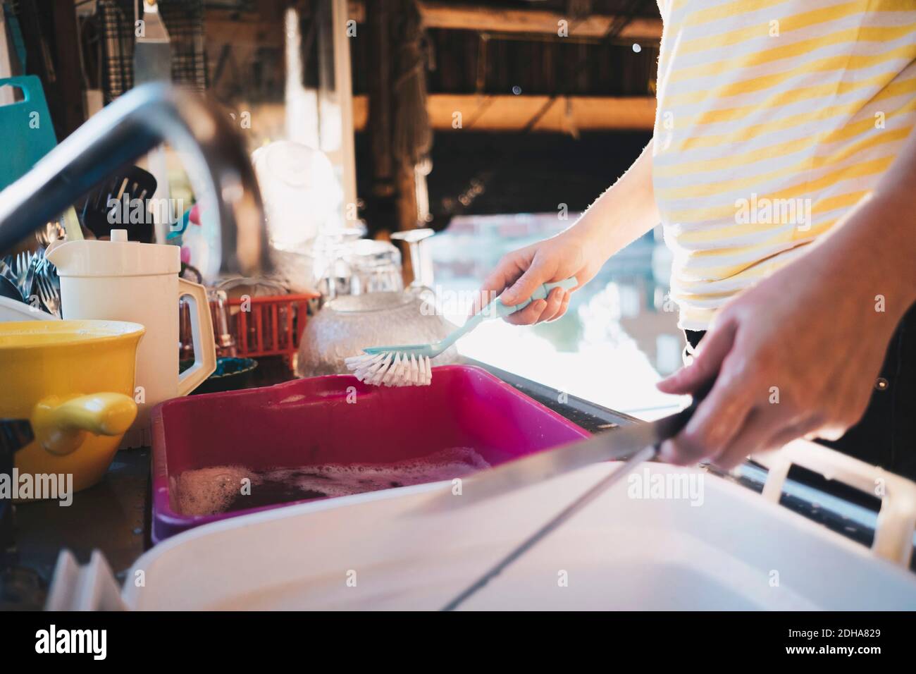 Midsection of woman working in kitchen at holiday villa Stock Photo - Alamy